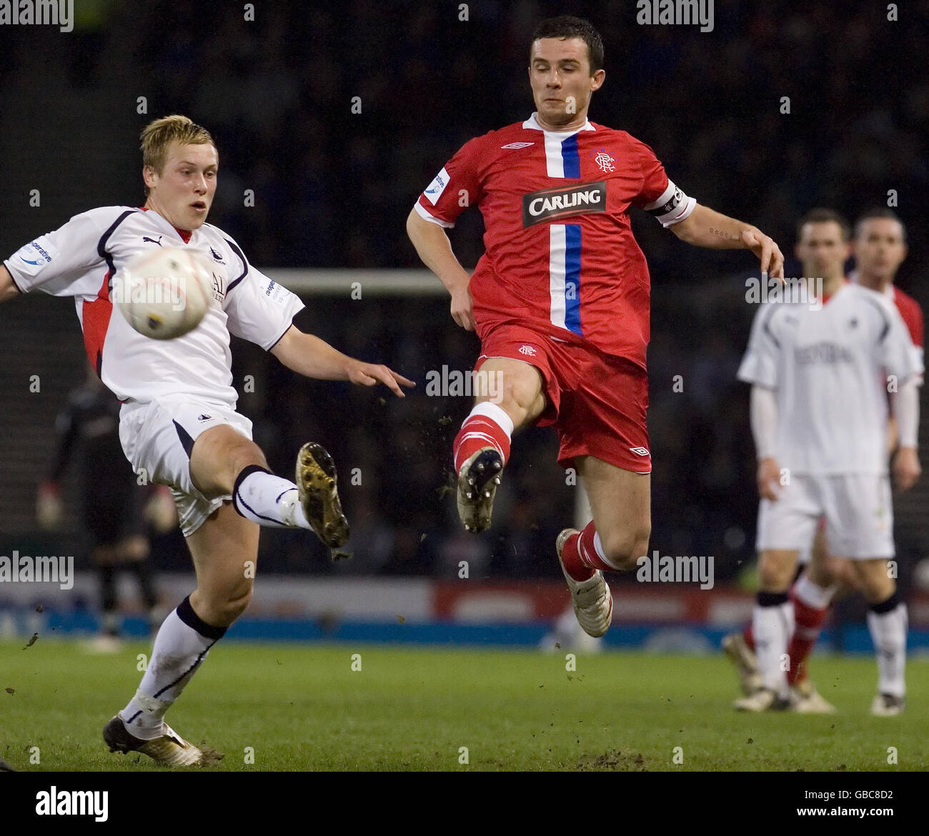 Rangers captain Barry Ferguson leaps to clear the ball from the path of ...