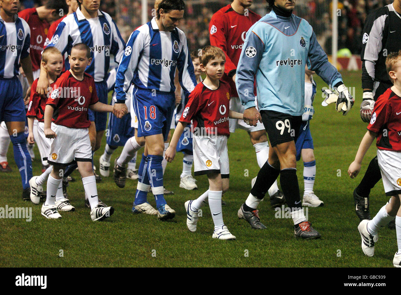 Mascots walk out with the players onto the pitch hi-res stock ...