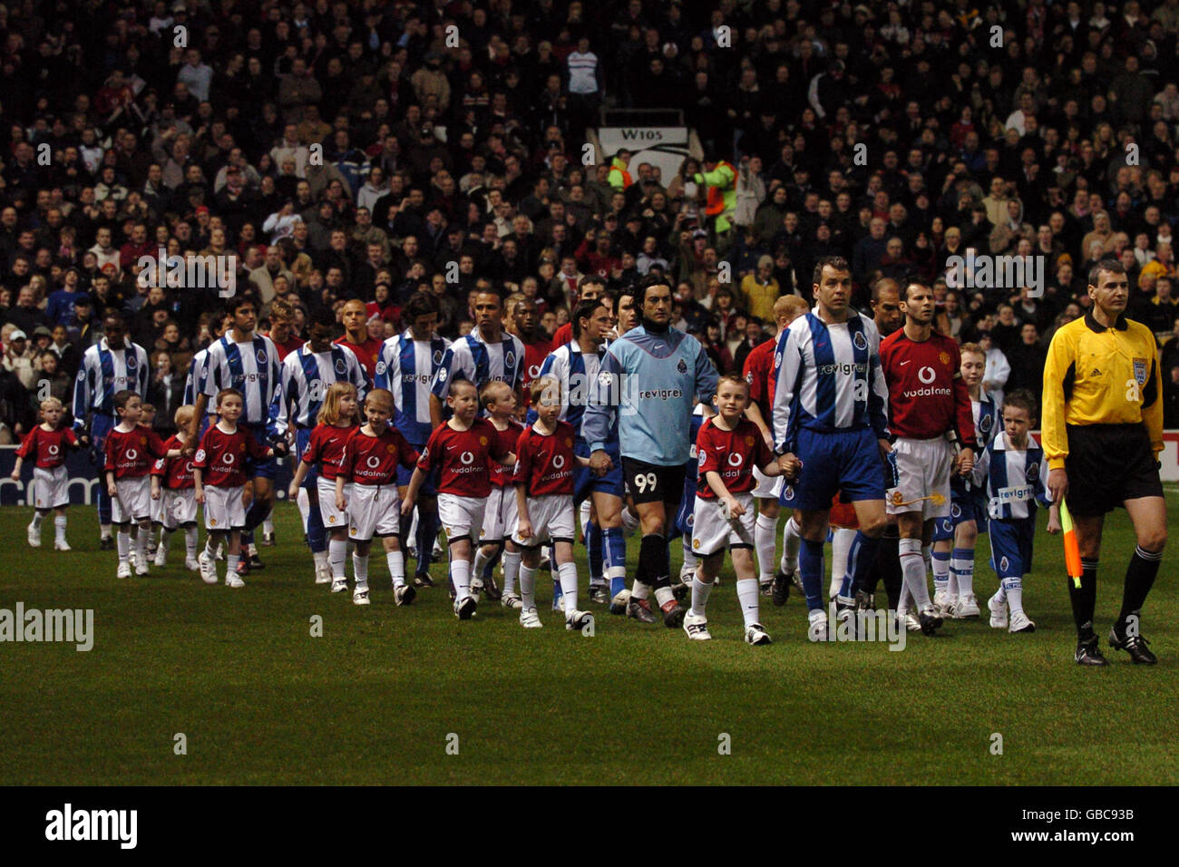 Mascots walk out with the players onto the pitch hi-res stock ...