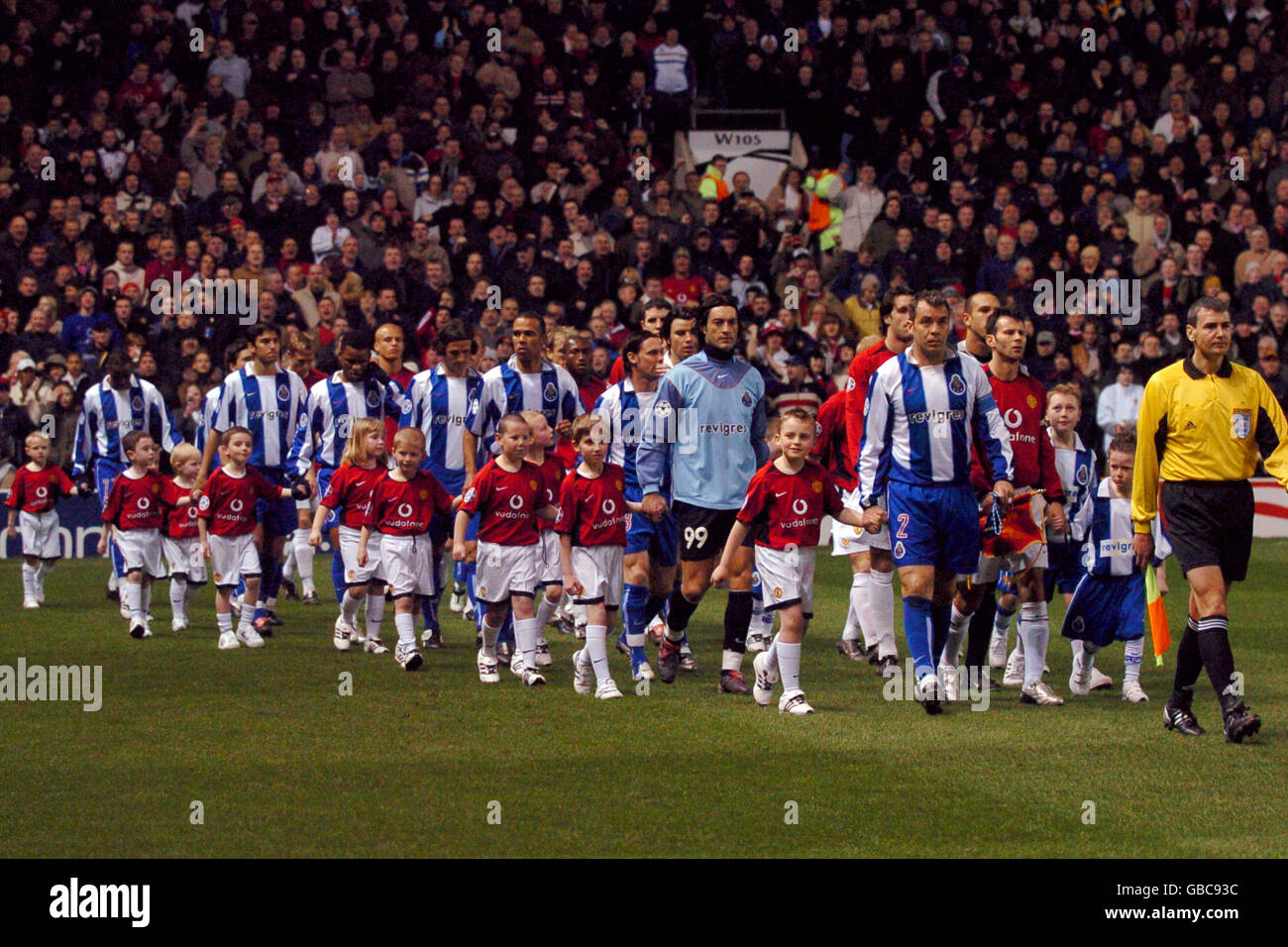 Mascots walk out with the players onto the pitch hi-res stock ...