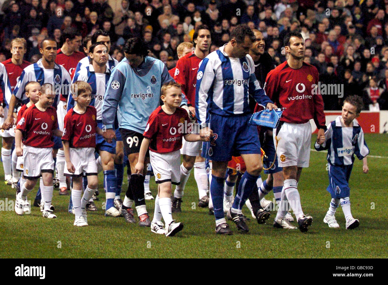 Mascots walk out with the players onto the pitch hi-res stock ...