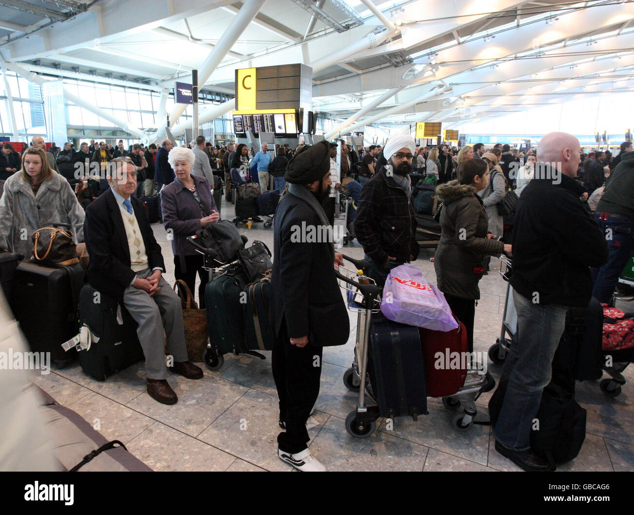 Passengers queue inside terminal 5 of heathrow airport hi-res stock ...