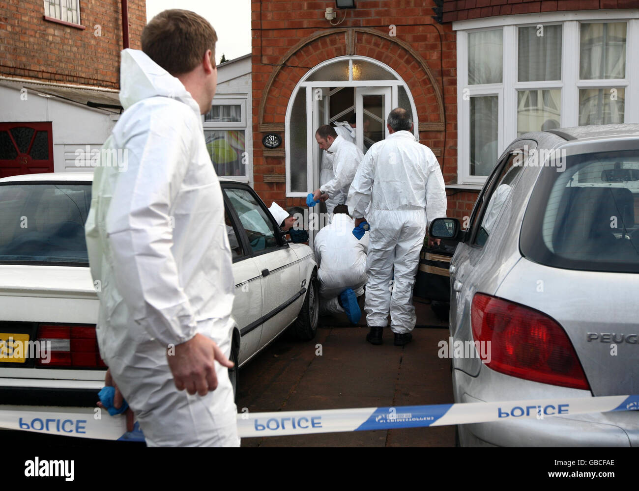 Police Forensic officers enter a house in Sheldon, Birmingham, after ...