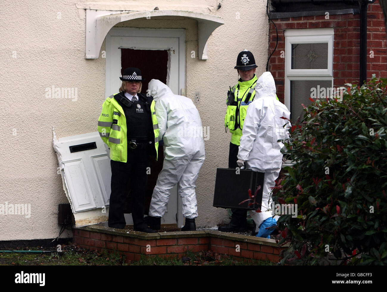 Police forensic officers enter a house in Shirley, Birmingham, after ...