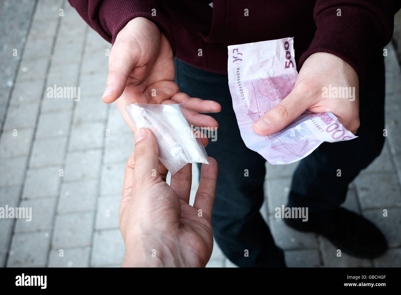 Pusher and drug addict exchanging money and drug Stock Photo - Alamy