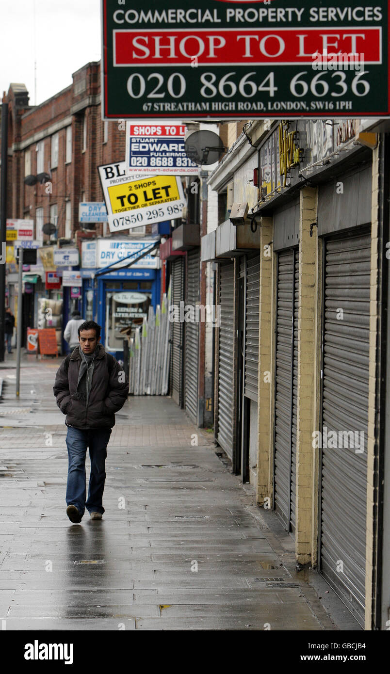 A man walks past shuttered shops on Streatham High Road in south London ...