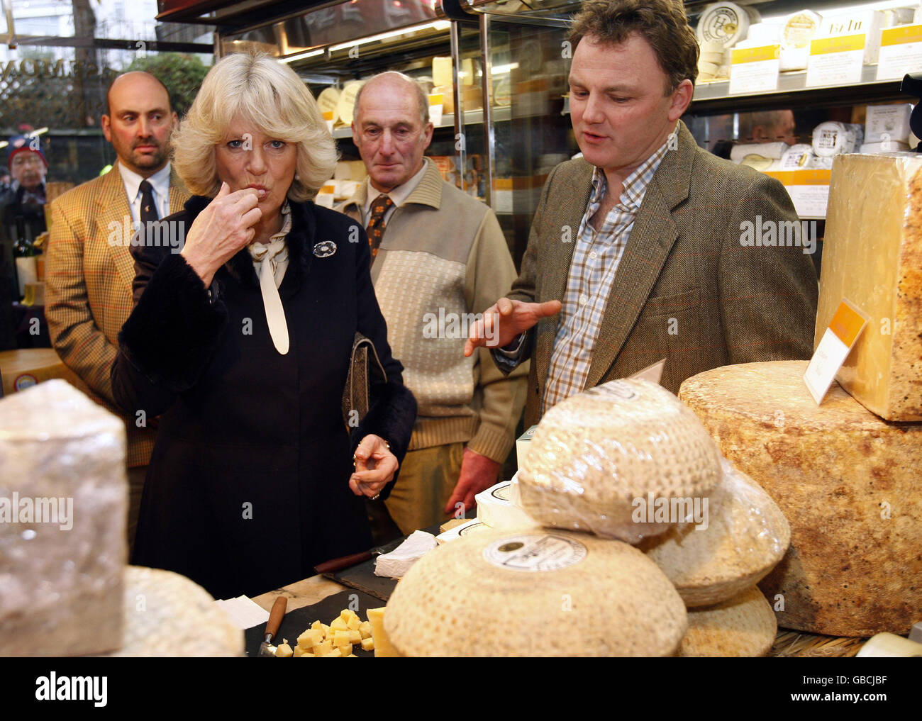 The Duchess of Cornwall, (left), tastes a cheese during a visit to ...