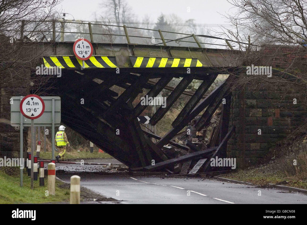 The collapsed railway bridge at the scene of an 'intensive' blaze after ...