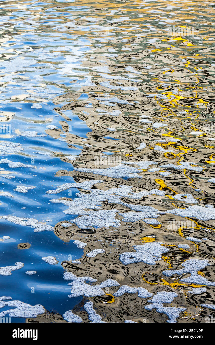 Polluted water with different colored patches on surface Stock Photo ...
