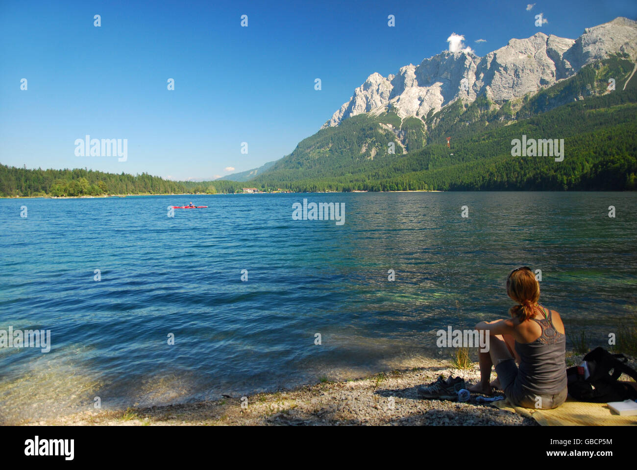 Woman at lake Eibsee, mountains Zugspitze, Grainau, Bavaria, Germany ...
