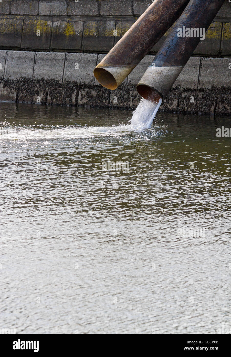 Dirty industrial wastes water flows from a drain pipe Stock Photo - Alamy