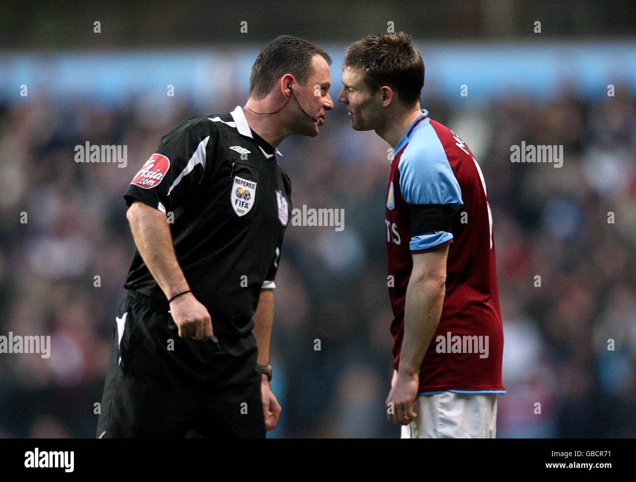 Aston Villa's James Milner and Referee Rob Styles (left Stock Photo - Alamy