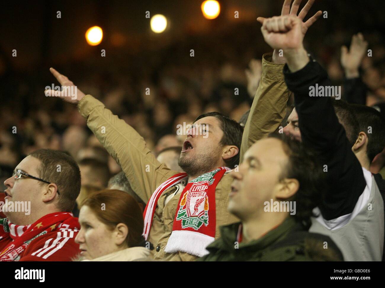 Liverpool fans cheer on their side in the stands hi-res stock ...