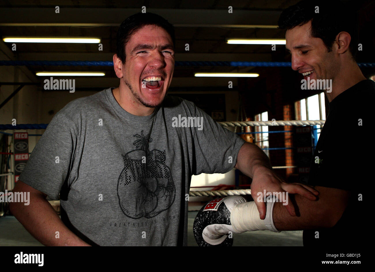 Trainer Anthony Farnell enjoys a light moment with boxer Steve Bell ...