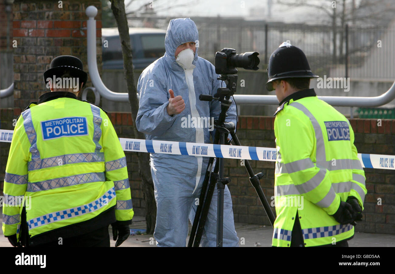 Police officers and a forensics officer at the scene of a murder on ...