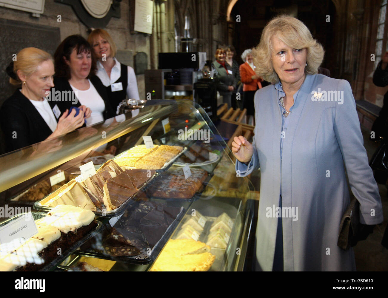 The Duchess of Cornwall (right) buys a brownie and some cake in the ...
