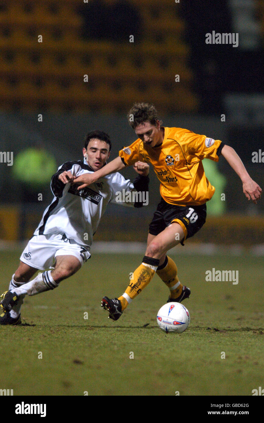 Cambridge United's David Bridges (r) and Swansea City's Leon Britton (l ...
