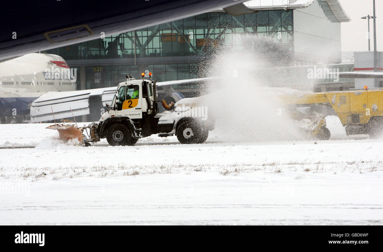 Snow Ploughs work hard at Heathrow Airport after the snow closed both ...