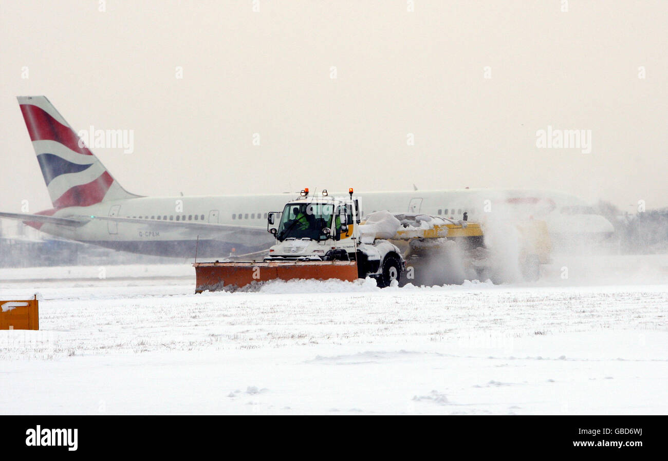 Snow Ploughs work hard at Heathrow Airport after the snow closed both ...