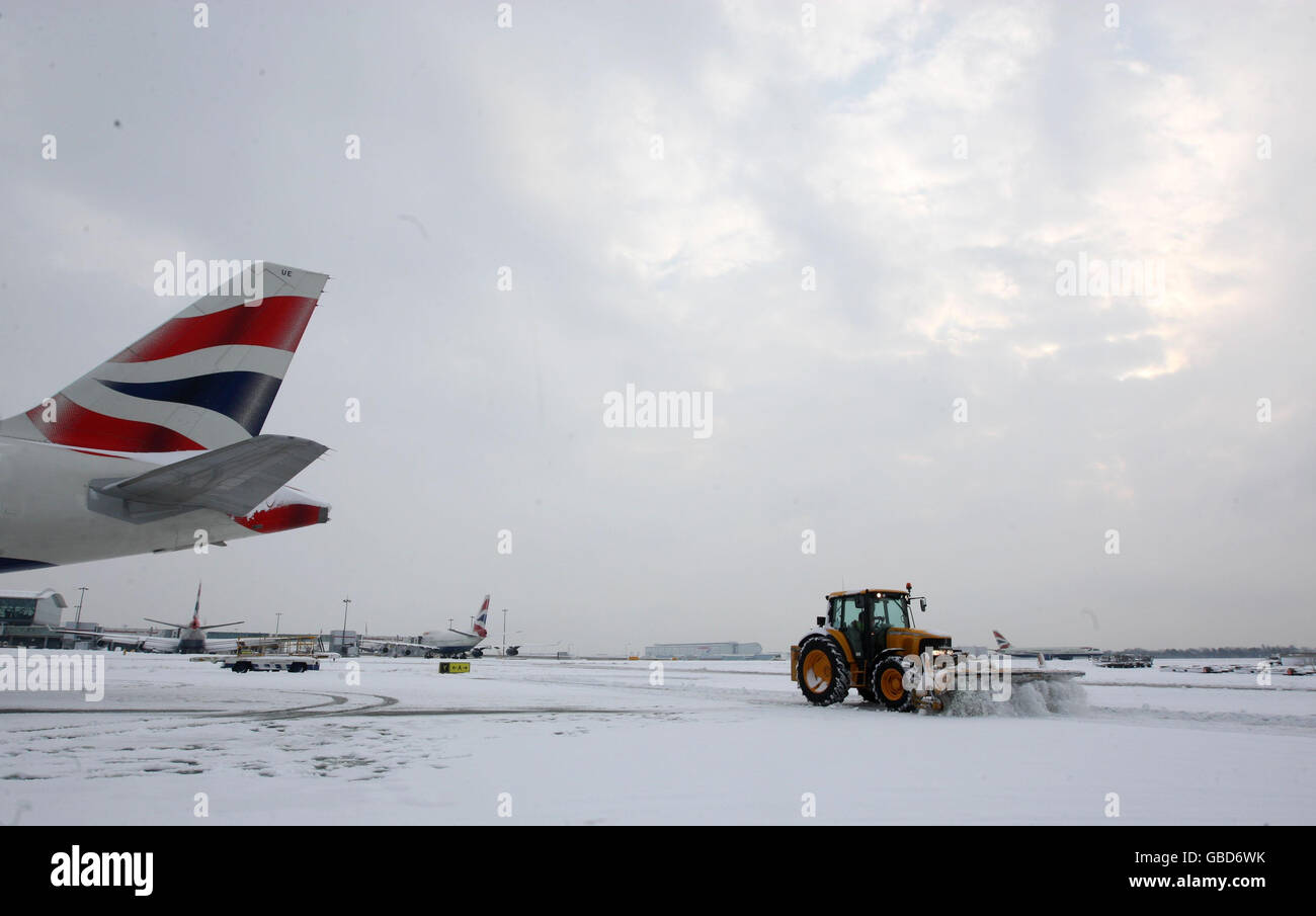 Snow Ploughs work hard at Heathrow Airport after the snow closed both ...