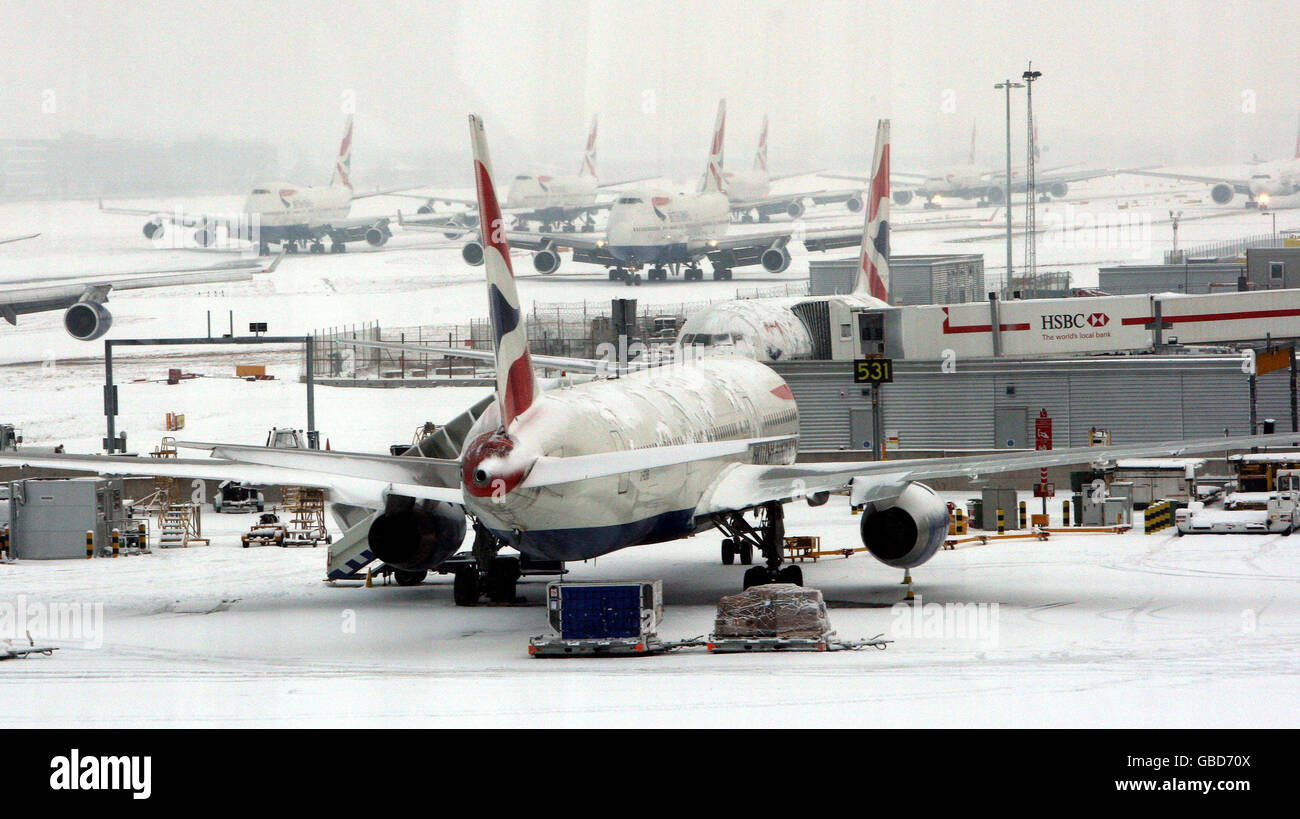 British Airways Planes wait in the snow outside Terminal 5 at Heathrow ...
