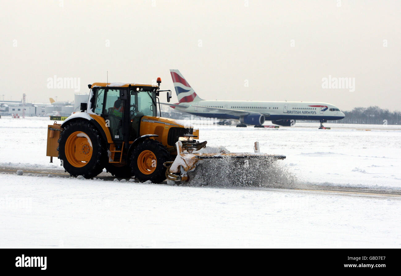 Snow Ploughs work hard at Heathrow Airport after the snow closed both ...