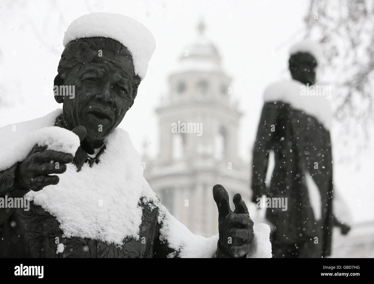 Snow covers the statue of Nelson Mandela in Parliament Square, central ...