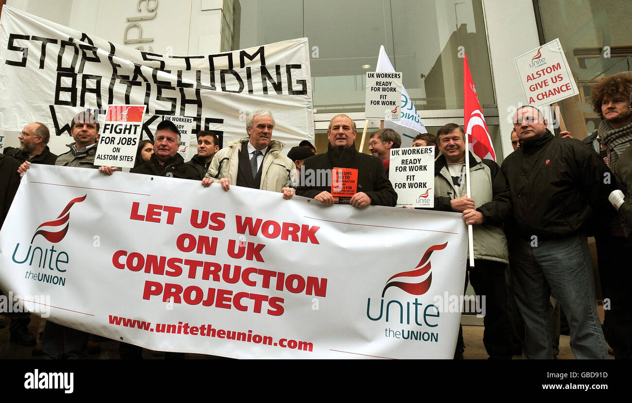 A group of British workers stand in a silent demonstration outside the ...
