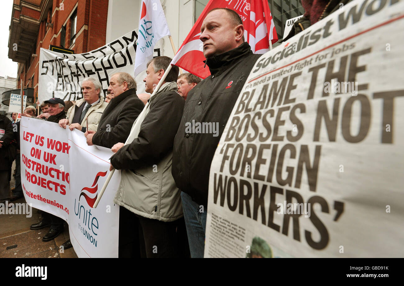 A group of British workers stand in a silent demonstration outside the ...