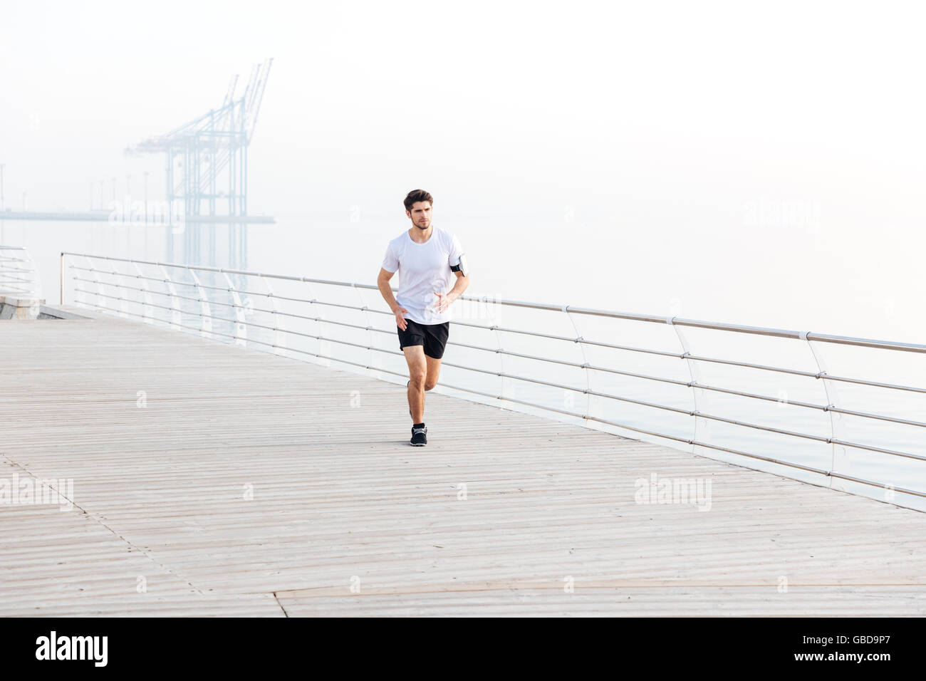 Handsome man athlete running outdoors in the morning Stock Photo - Alamy