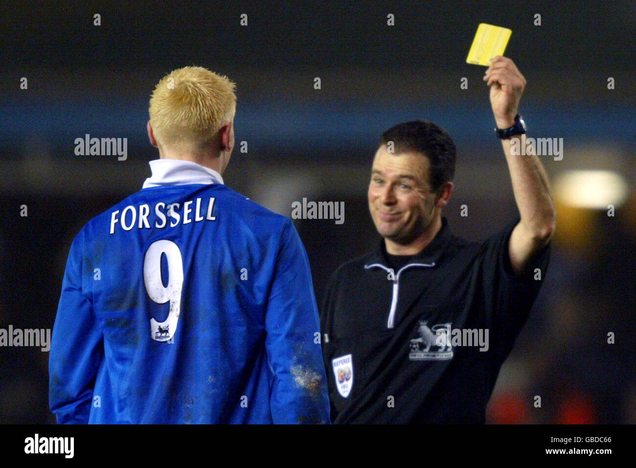 Referee Rob Styles (r) shows the yellow card to Birmingham City's ...