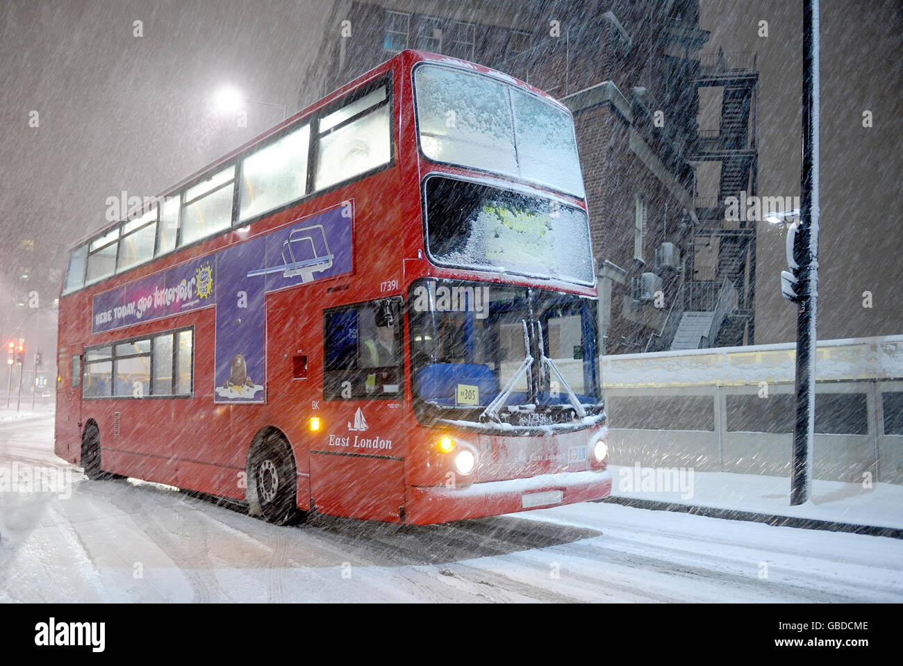 Winter weather. A bus struggles up a hill as heavy snow falls in ...