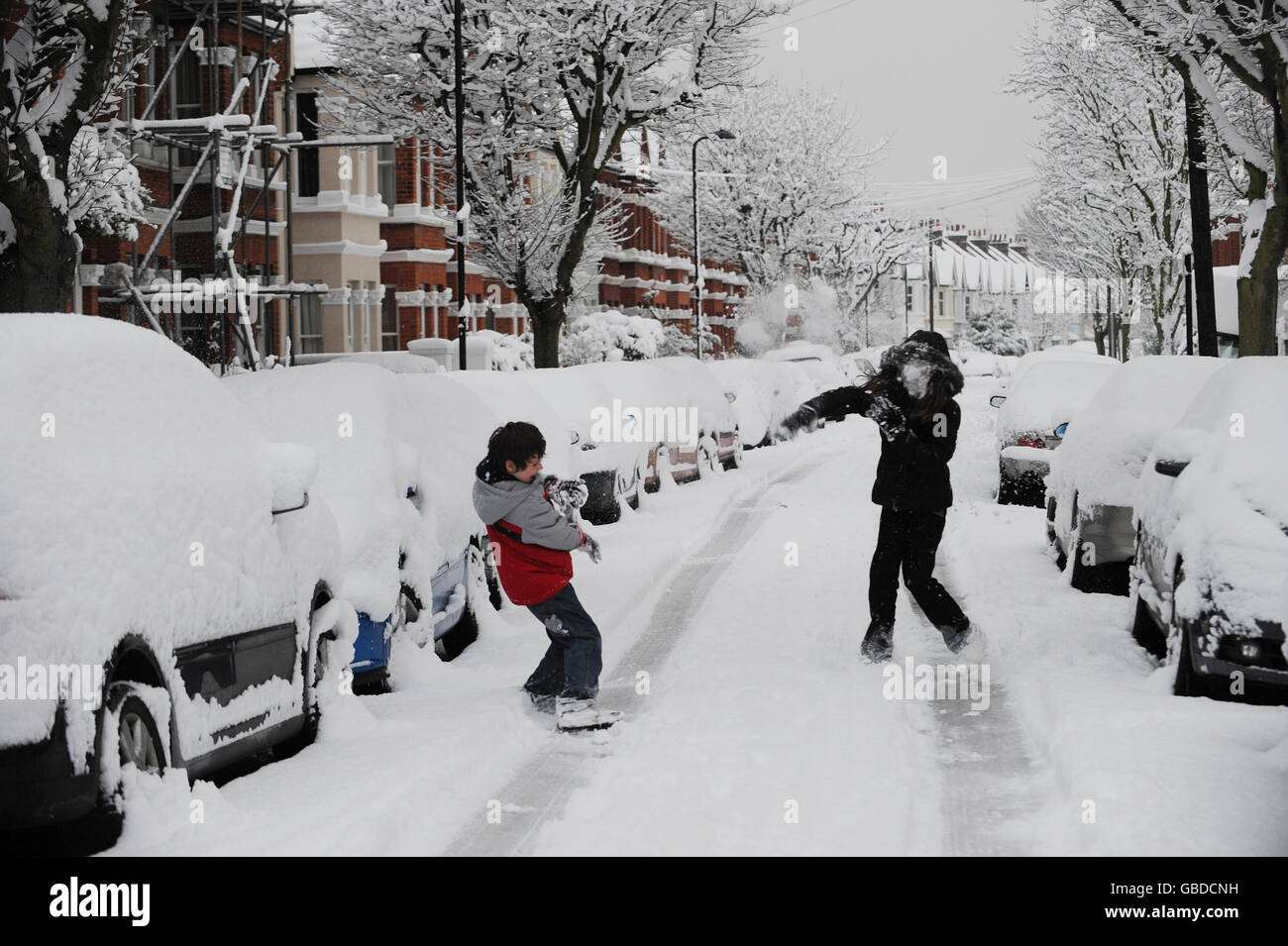 A snowball fight erupts on a street in Chiswick, London, as heavy ...