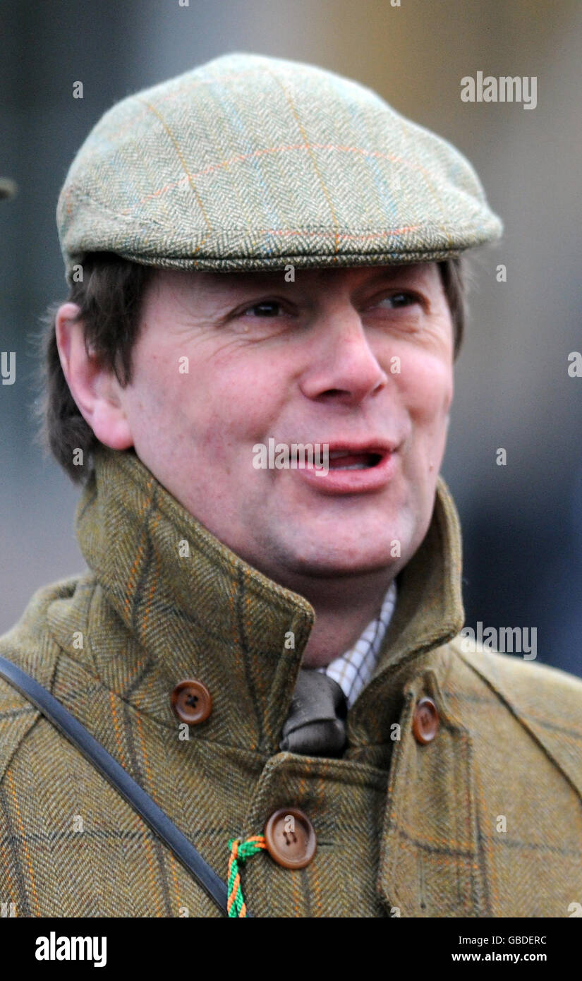 Trainer Chris Wall looks-on as Premio Loco ridden by George Baker goes ...