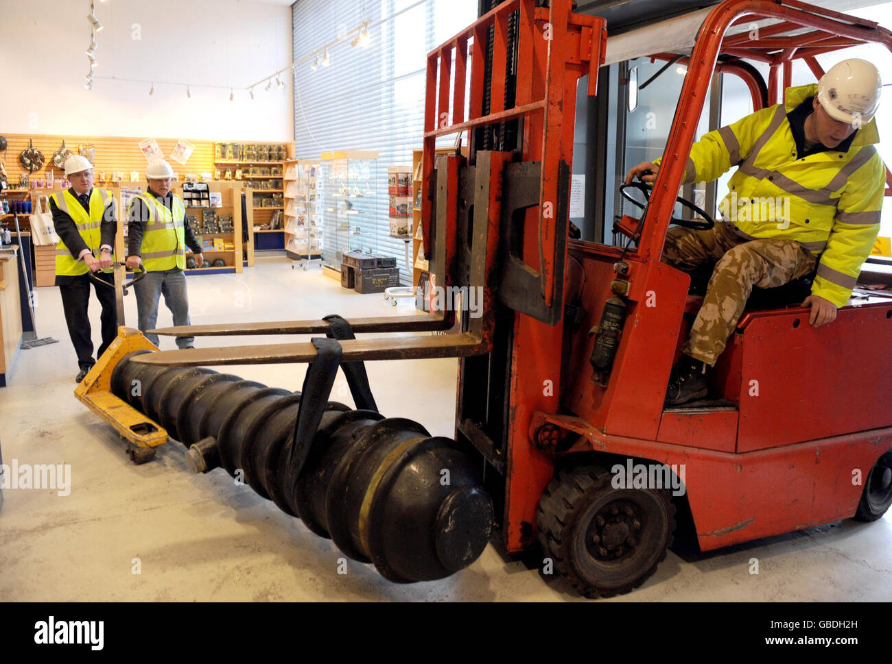 Firepower exhibition. Workers move a cannon from the trophy gallery to ...
