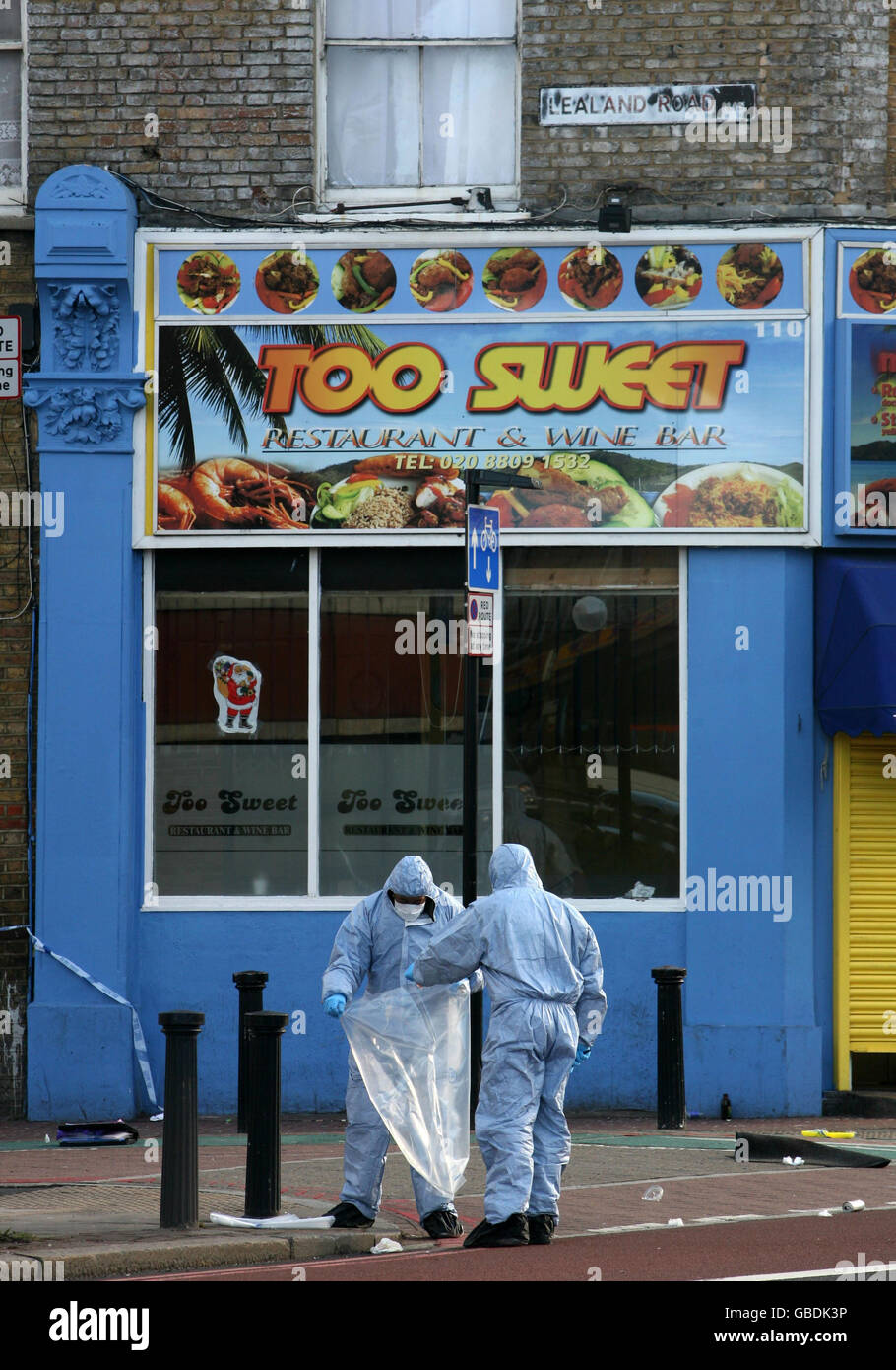 Crime officers search the area outside Too Sweet restaurant, Tottenham ...