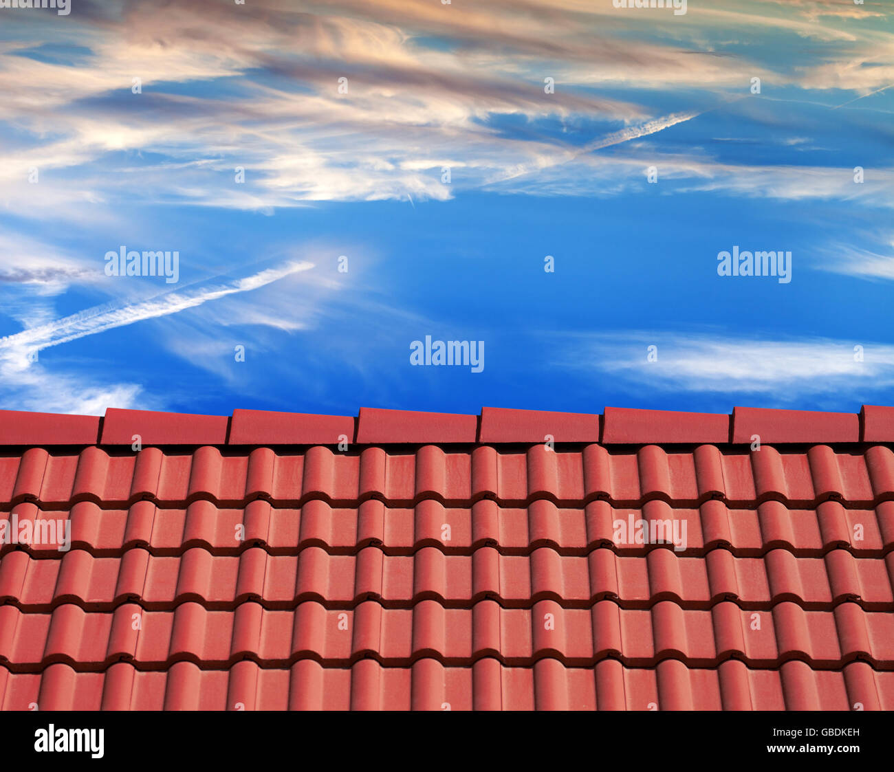 Roof tiles and sunset sky with sunlight clouds Stock Photo - Alamy