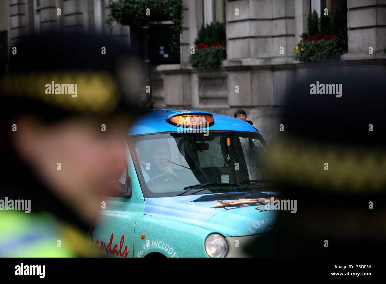 Taxis line up in Whitehall, London, protesting against a new scheme for ...