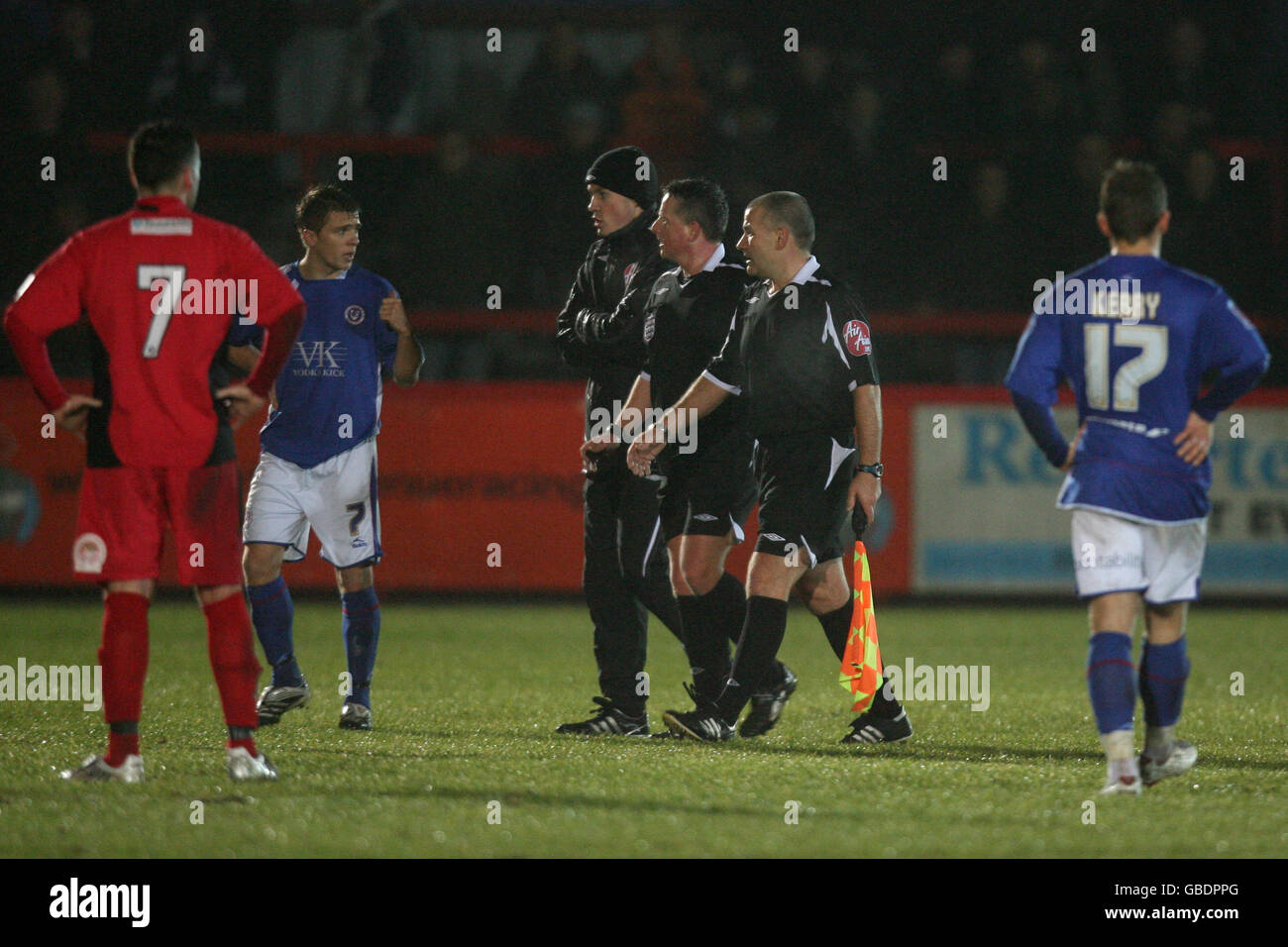 Referee Colin Webster (third right) leads away his assistant Paul Curry ...