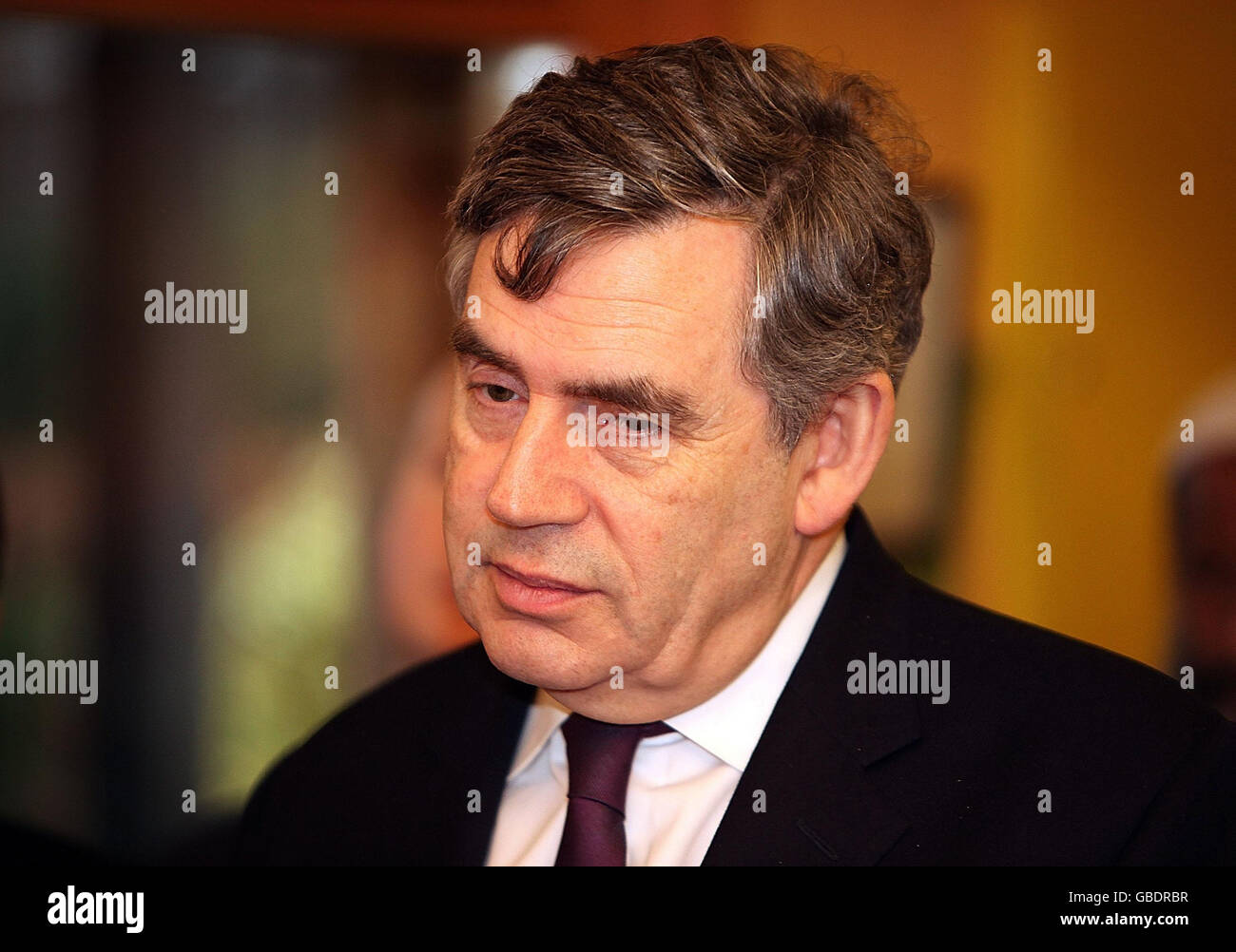 Prime Minister Gordon Brown listens to workers on a visit to the ...