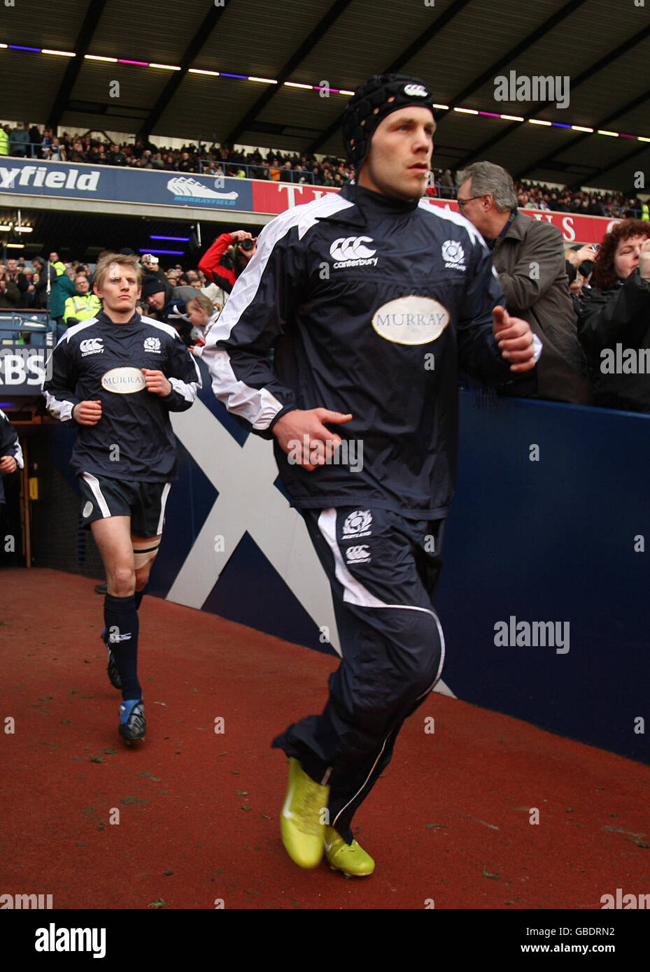 Scotland's Simon Webster and Ben Cairns run out of the tunnel before ...