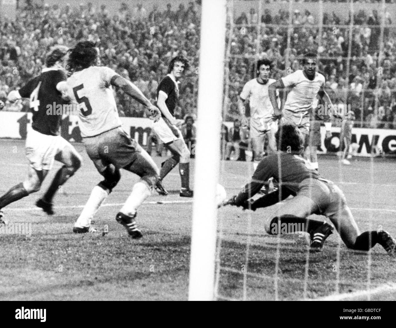 Brazil goalkeeper Leao (r, diving) saves a header from Scotland's Joe ...