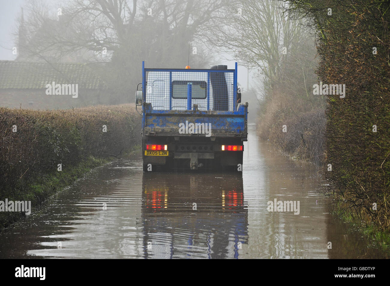 A lorry has to reverse out of danger in the flood water that has ...