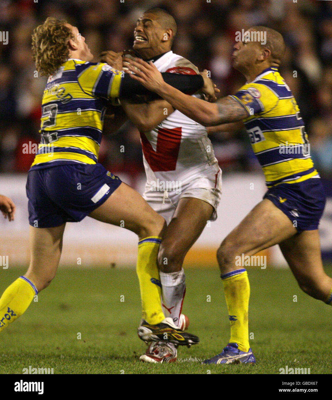 St Helens' Leon Pryce is tackled by Matty Blythe (right) and Ben ...