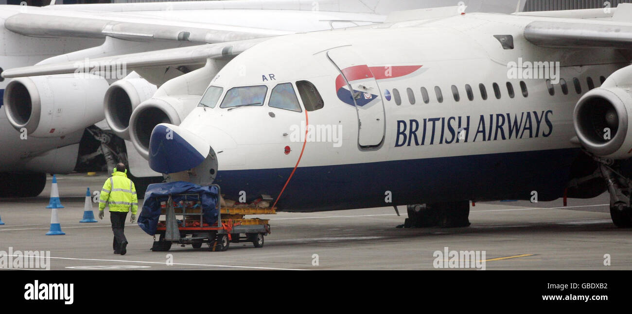 A damaged British Airways plane is examined at City Airport in London ...