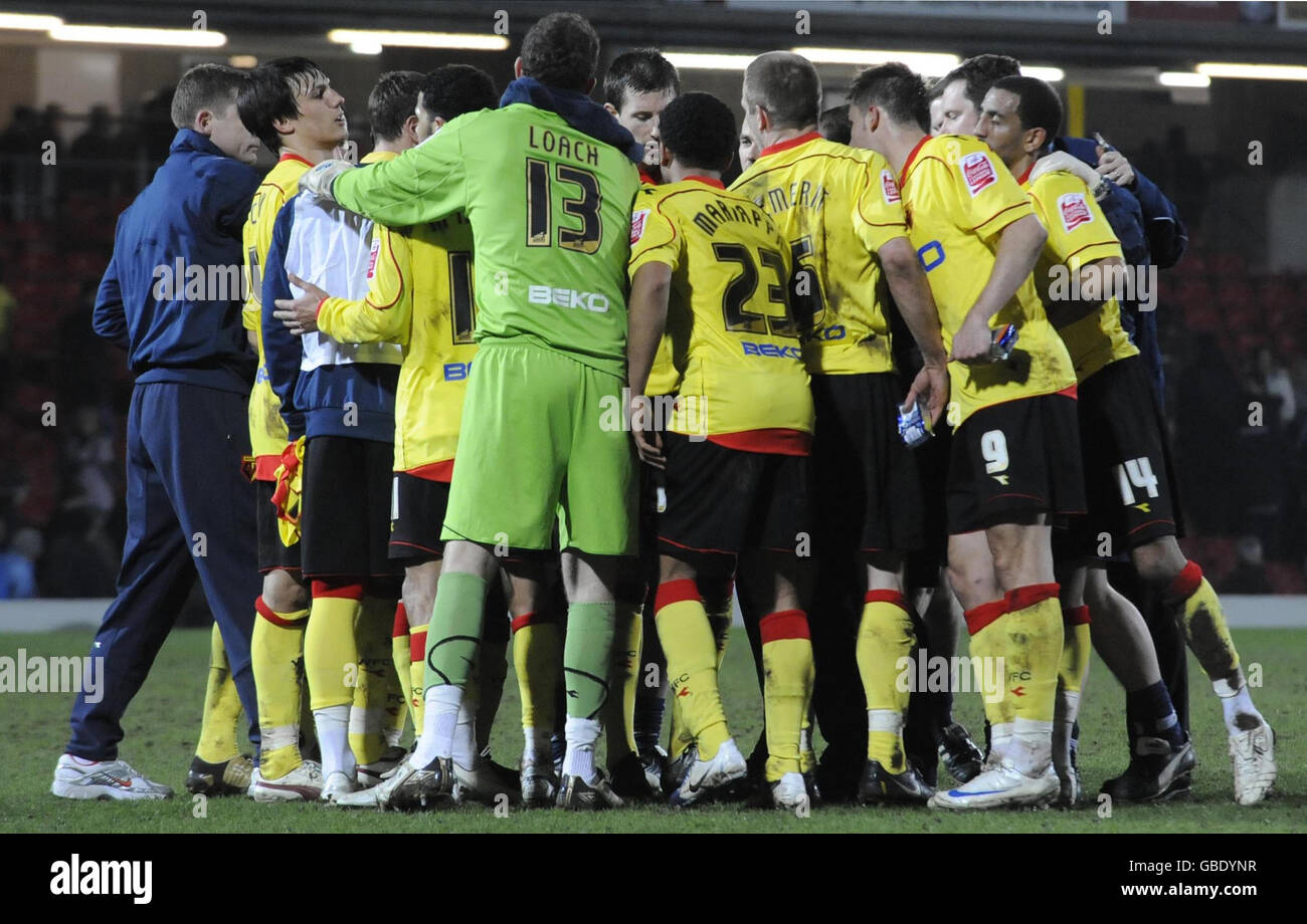 The Watford squad gather with manager Brendan Rodgers (obscured) at end ...