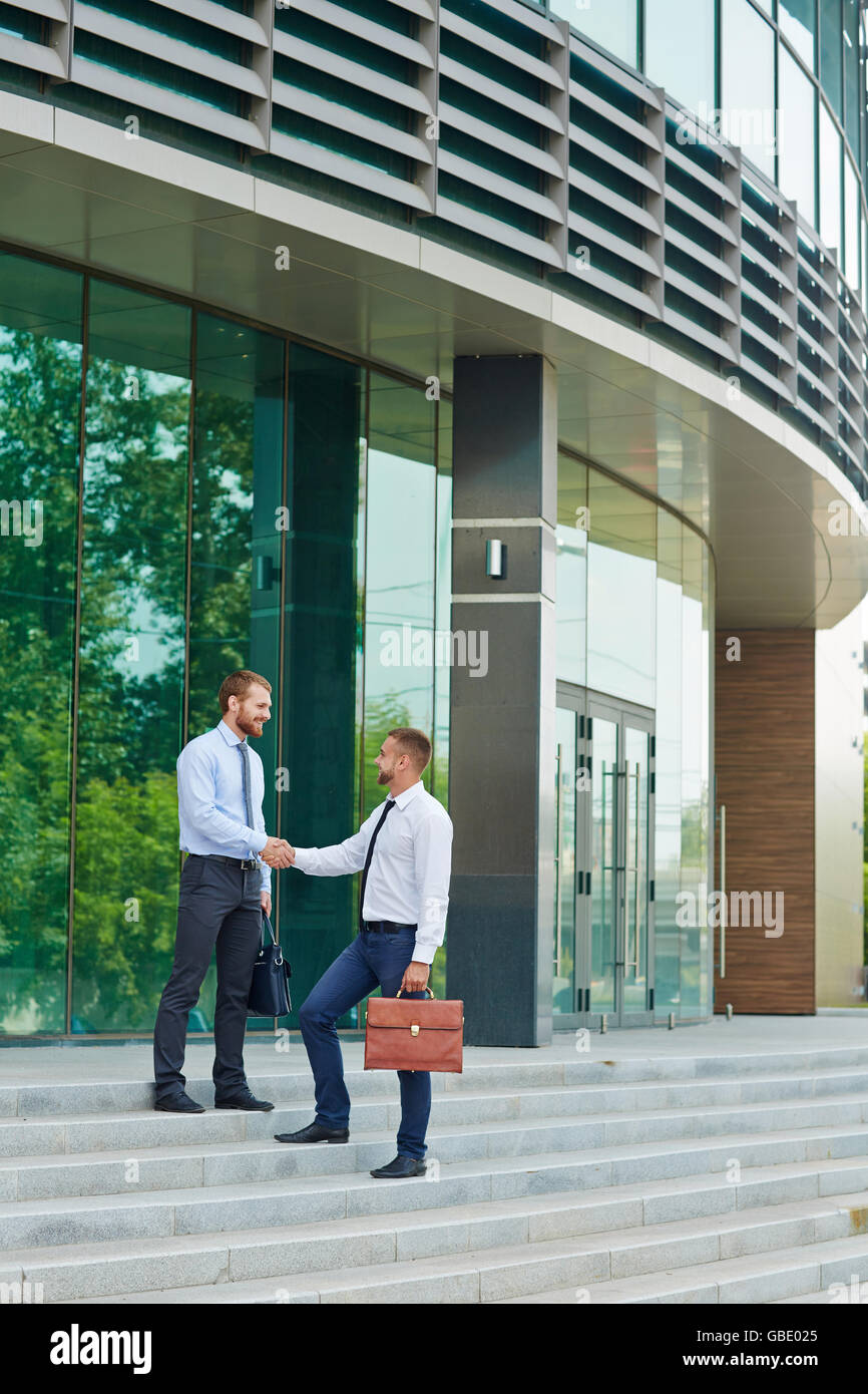 Businessman greeting his colleague by handshake in the morning Stock ...