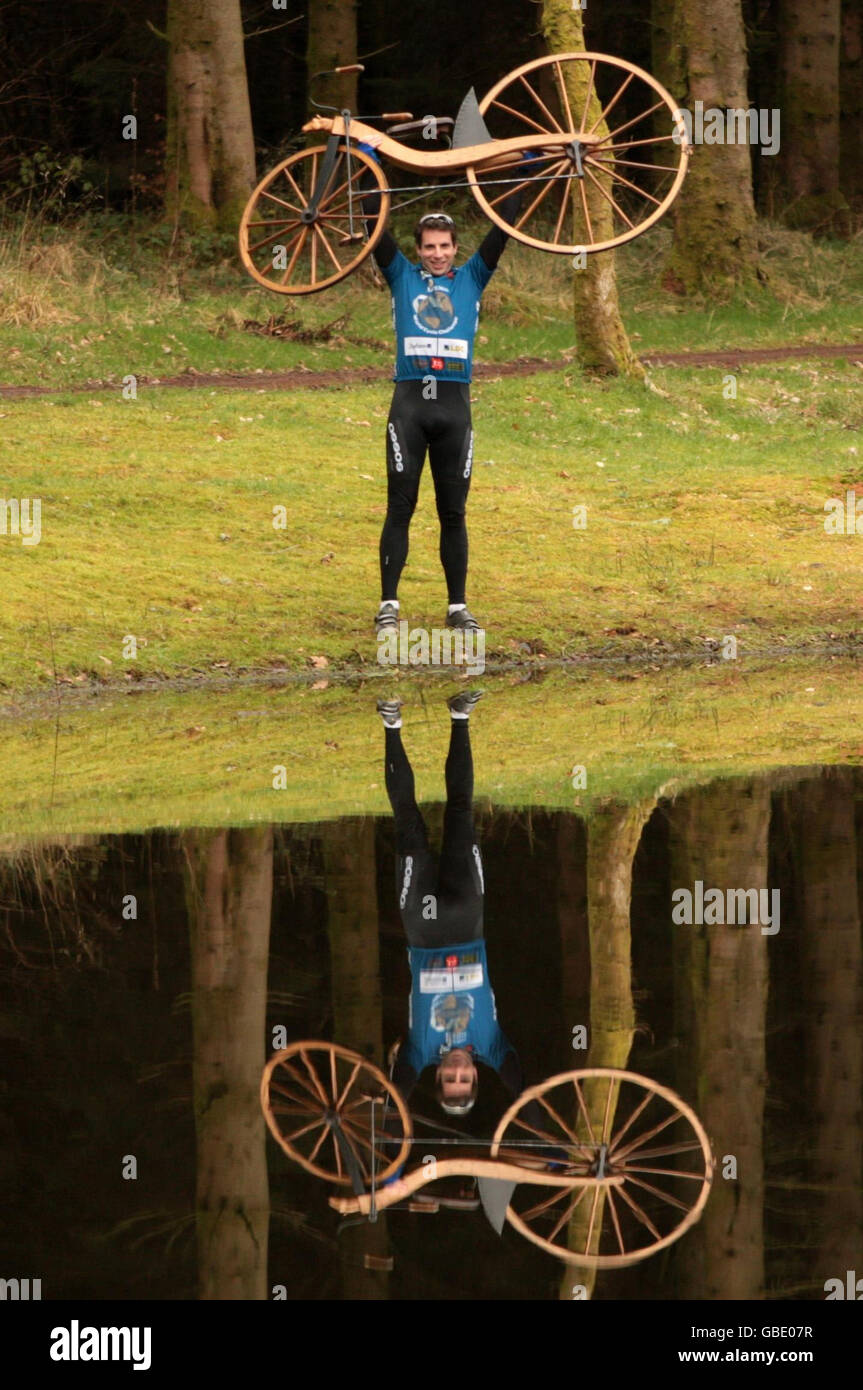World record cyclist Mark Beaumont holds up a replica of an iron ...
