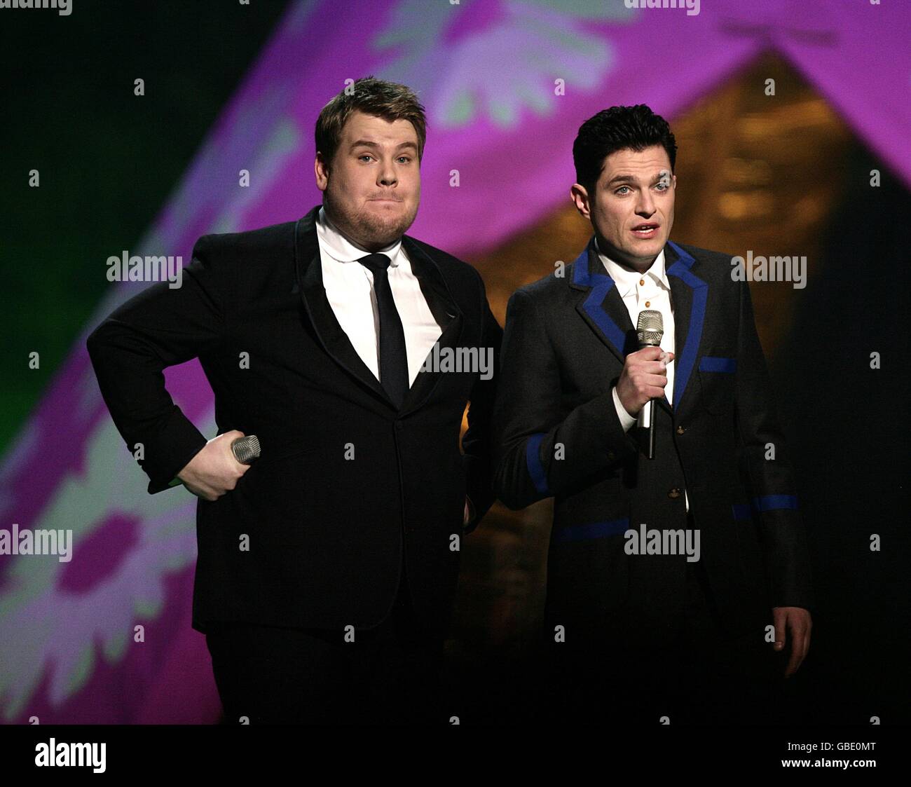 Mathew Horne (right) and James Corden present on stage, during the BRIT ...