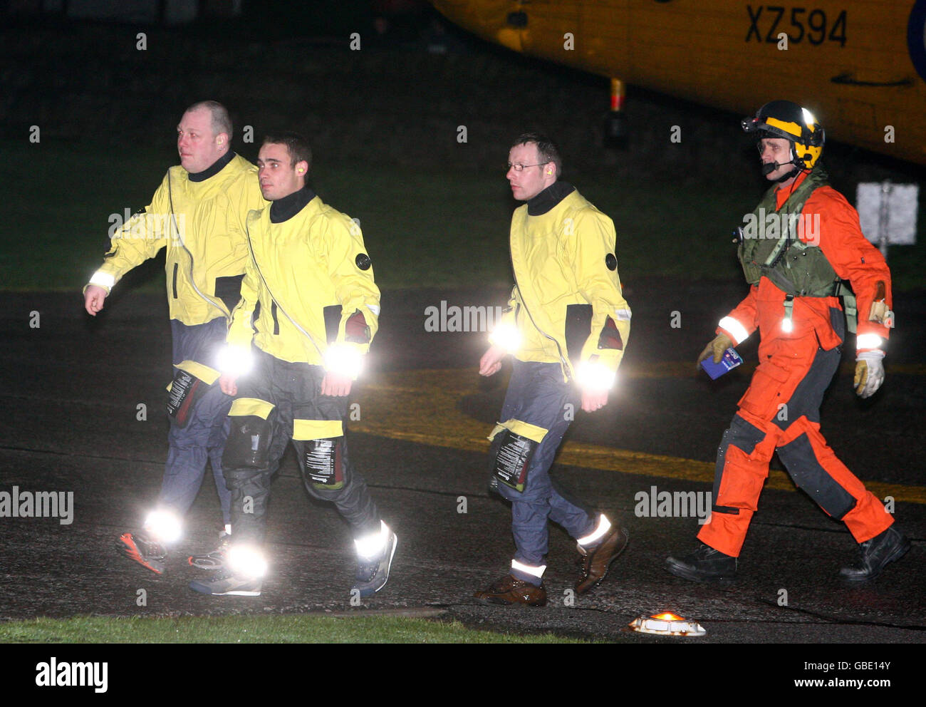 Rescued crew from the ditched helicopter arrive at the helipad at the ...